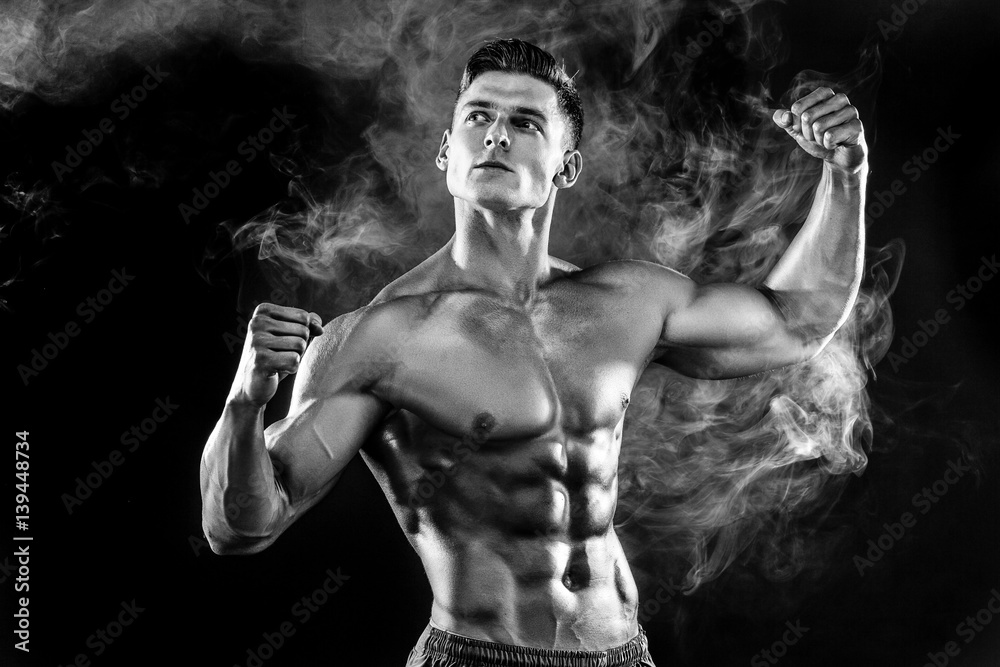 Strong bodybuilder man with perfect body- abs, shoulders, biceps ...