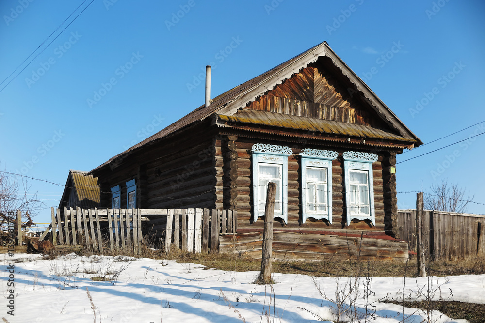 Old log house in the remote Russian village in the early spring against ...