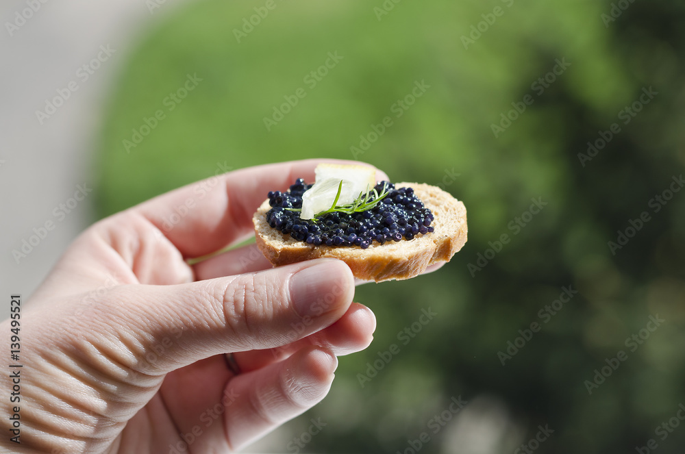 Woman hand with small piece of food Stock Photo | Adobe Stock