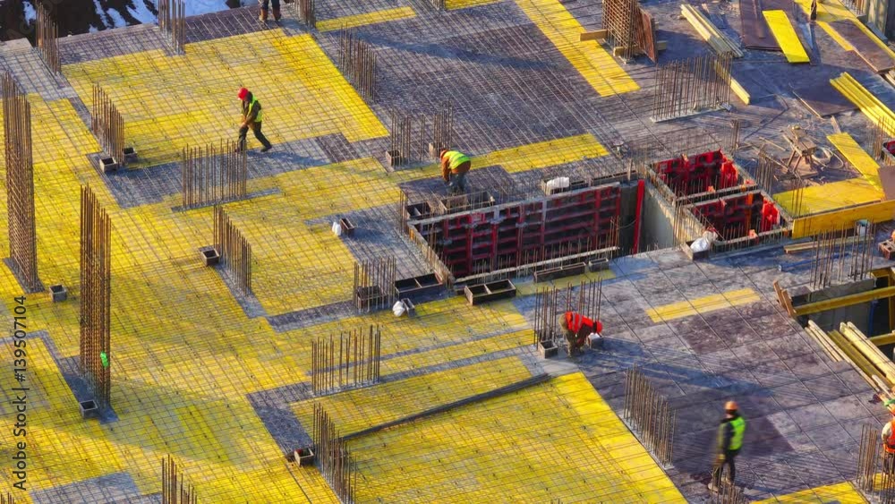 Top view of construction workers at construction site. Builders laids ...