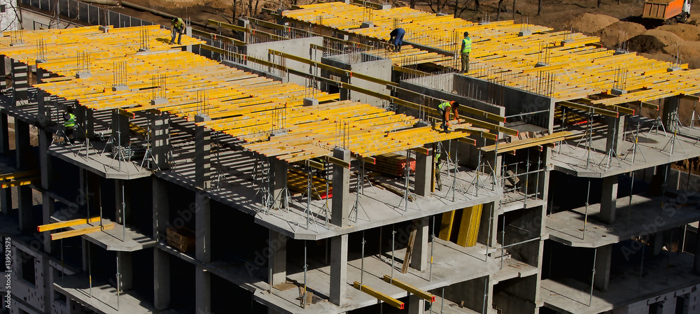 Construction workers installing mounting horizontal formwork on the ...