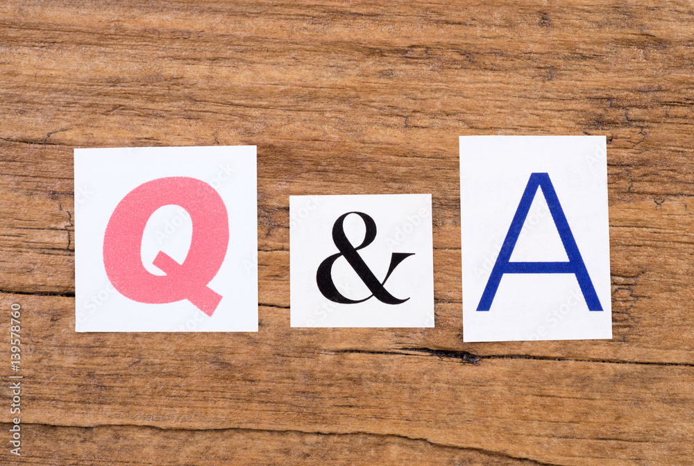Phrase "Q and A" in cut out magazine letters on wooden background Stock ...