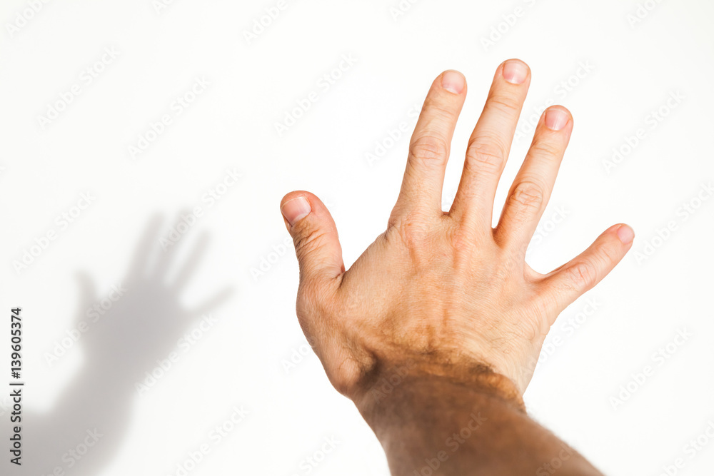 Male hand over white wall background Stock Photo | Adobe Stock