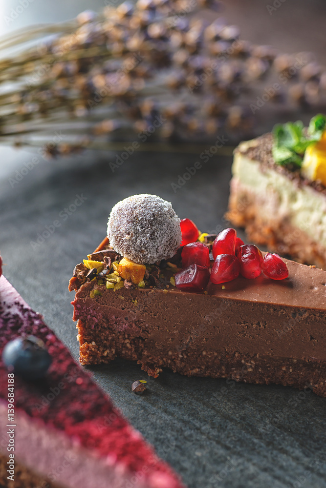raw vegan cake with fruits and seeds, decorated with flowers, product photography for patisserie ...