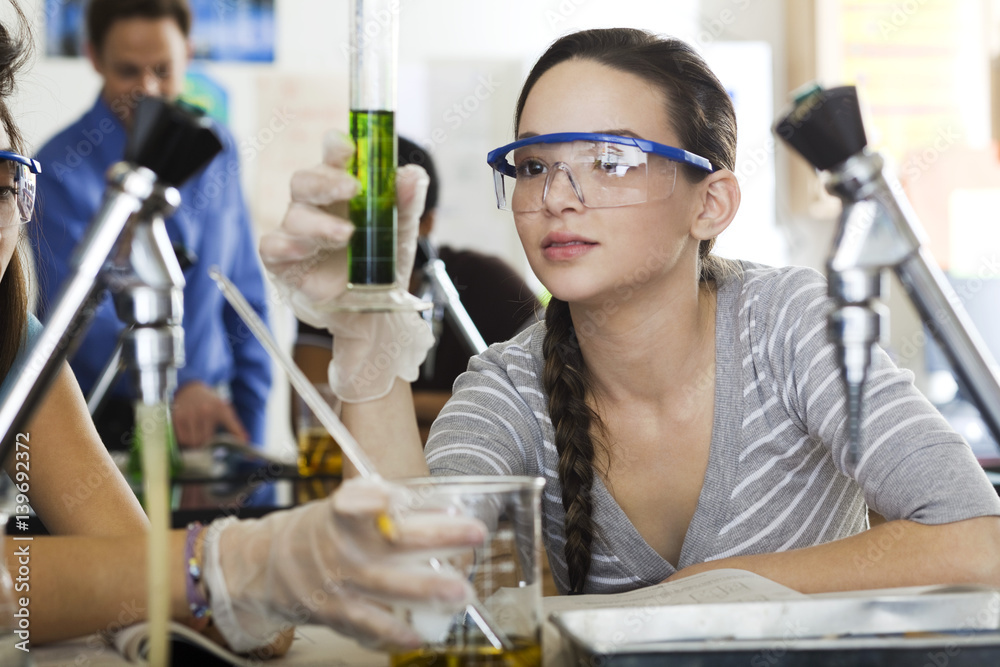 High school student conducting experiment in science class Stock Photo ...