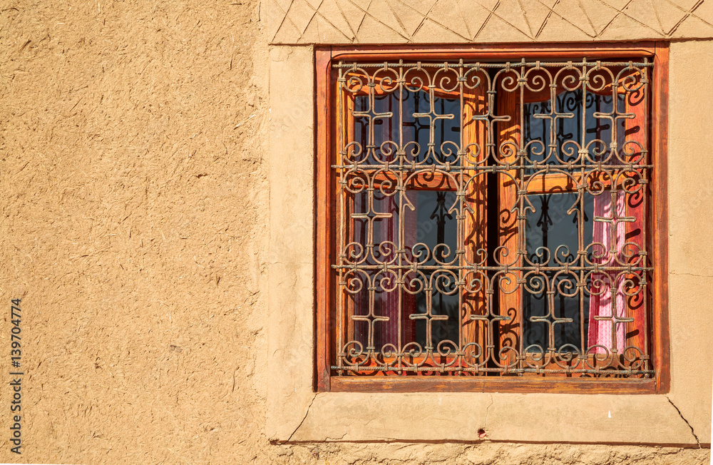 Rammed earth wall with traditional wrought iron window Stock Photo ...