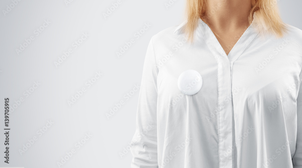 Blank button badge mockup pinned on the womans chest, close up view ...