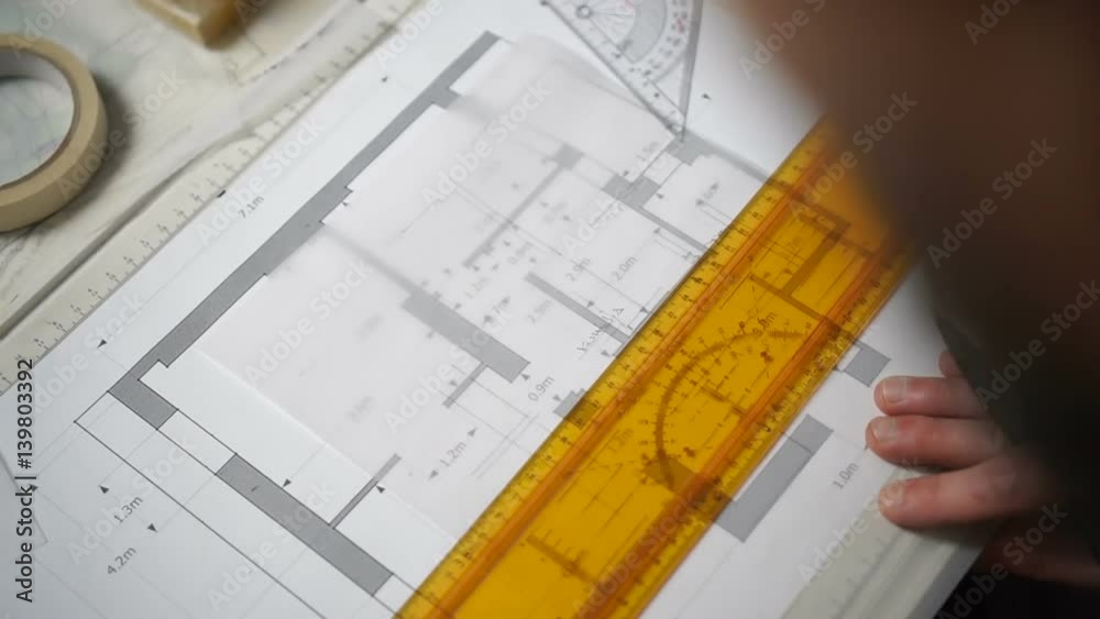 Video Stock Architect drawing blueprints plan, graph, design, geometric ...