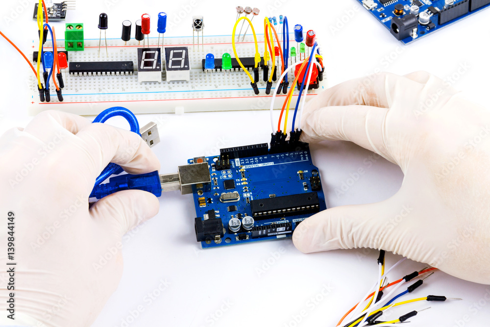 Engineer is connecting microchip to microcontroller with the help of ...