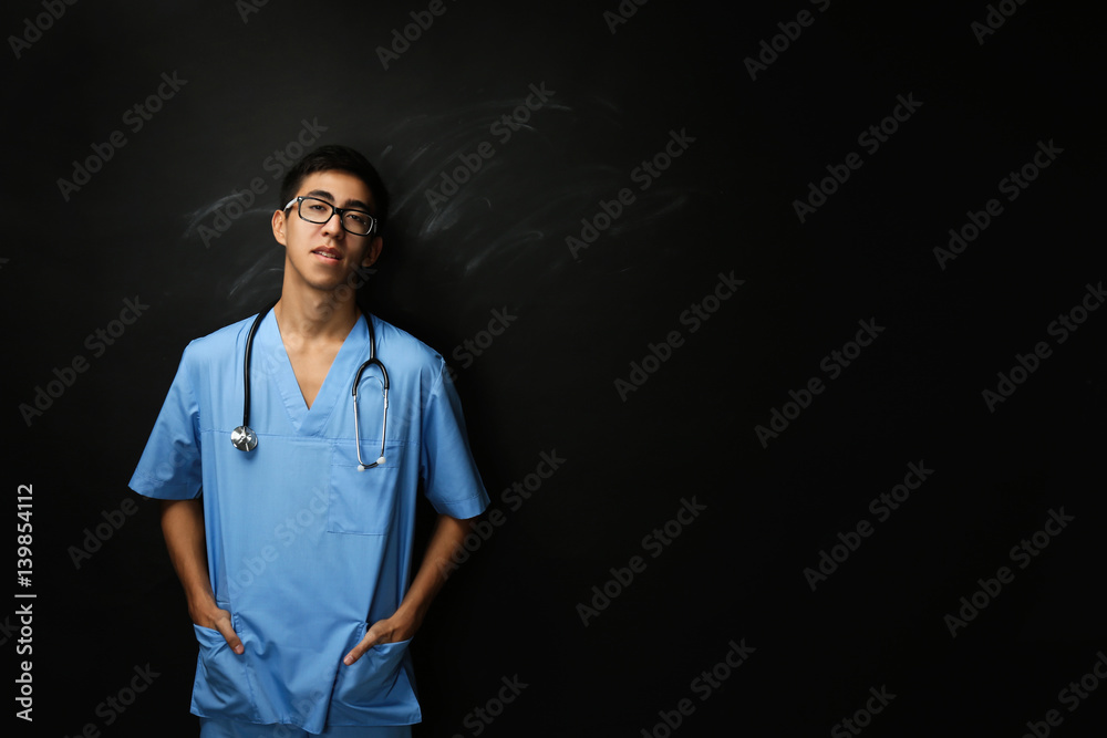 Young handsome medical student on blackboard background Stock Photo ...