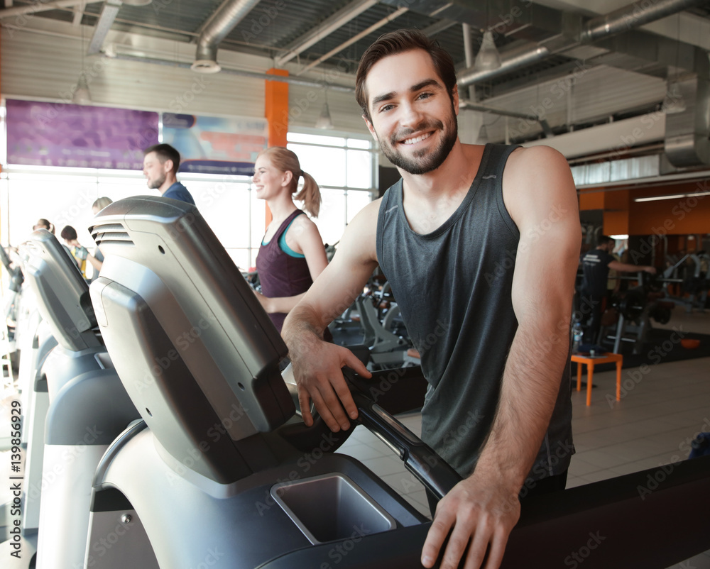 Young sporty man on treadmill in gym Stock Photo | Adobe Stock