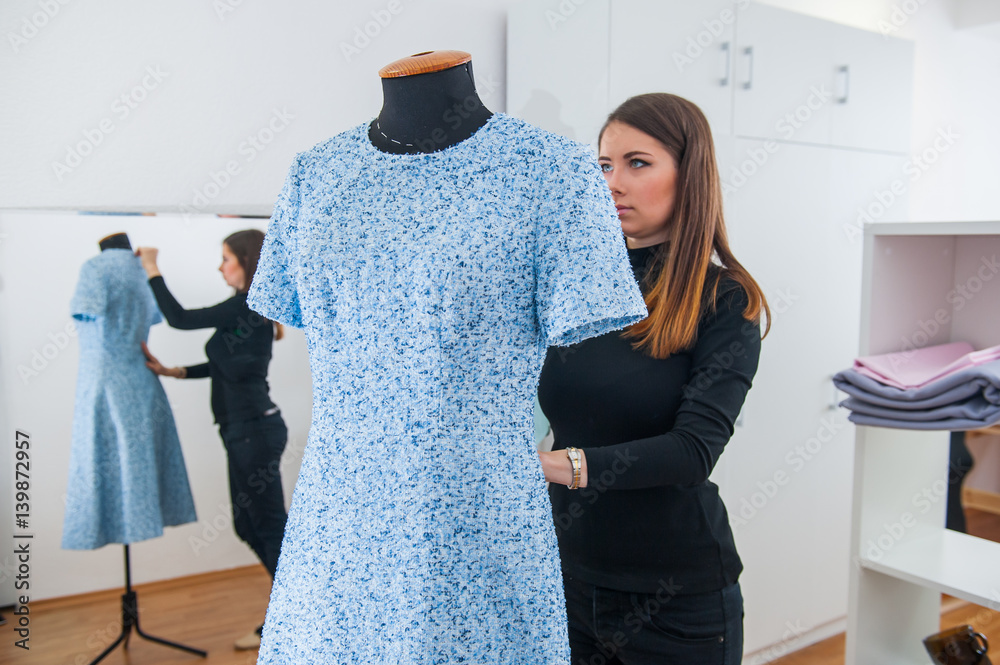 Female seamstress prepares dress to the fitting. Selective focus Stock ...