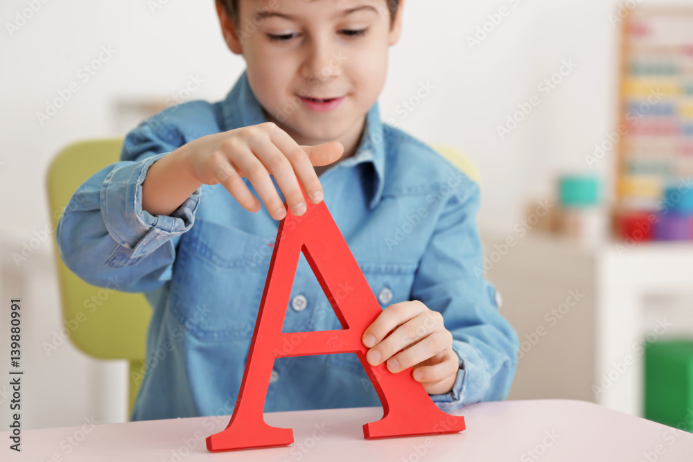 Cute little boy with letter A at speech therapist office Stock Photo ...
