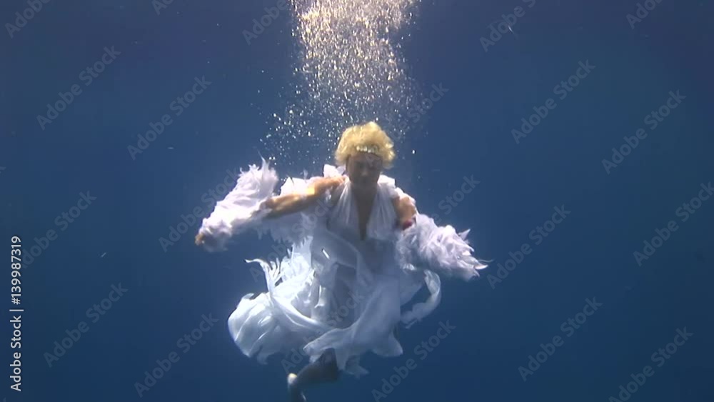 Young girl model free diver underwater white angel costume poses in Red ...