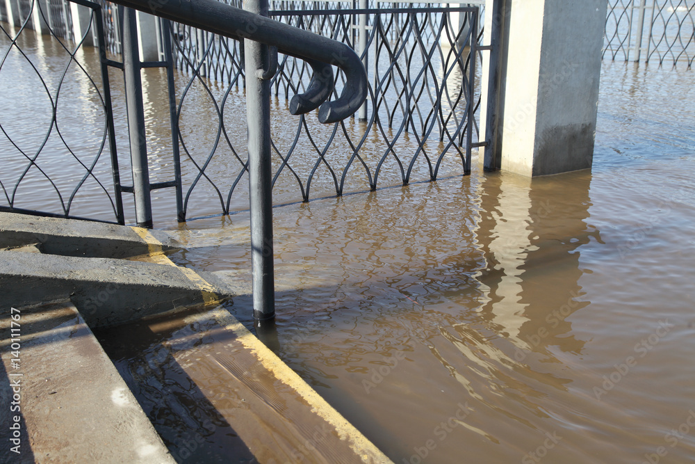 Flooding in the city. Flooding of the bank of the river in the spring ...