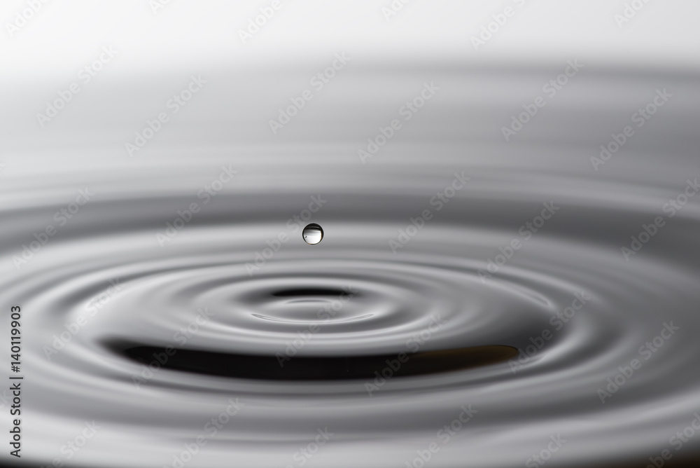 Water drop falling into water making a concentric circles Stock Photo ...