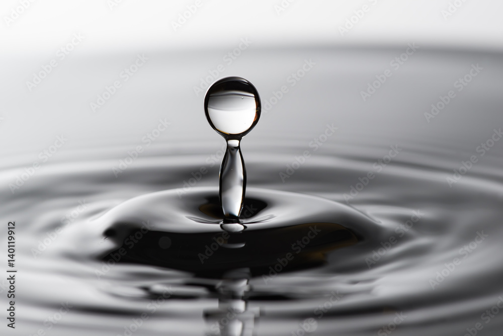 Water drop falling into water making a concentric circles Stock Photo ...