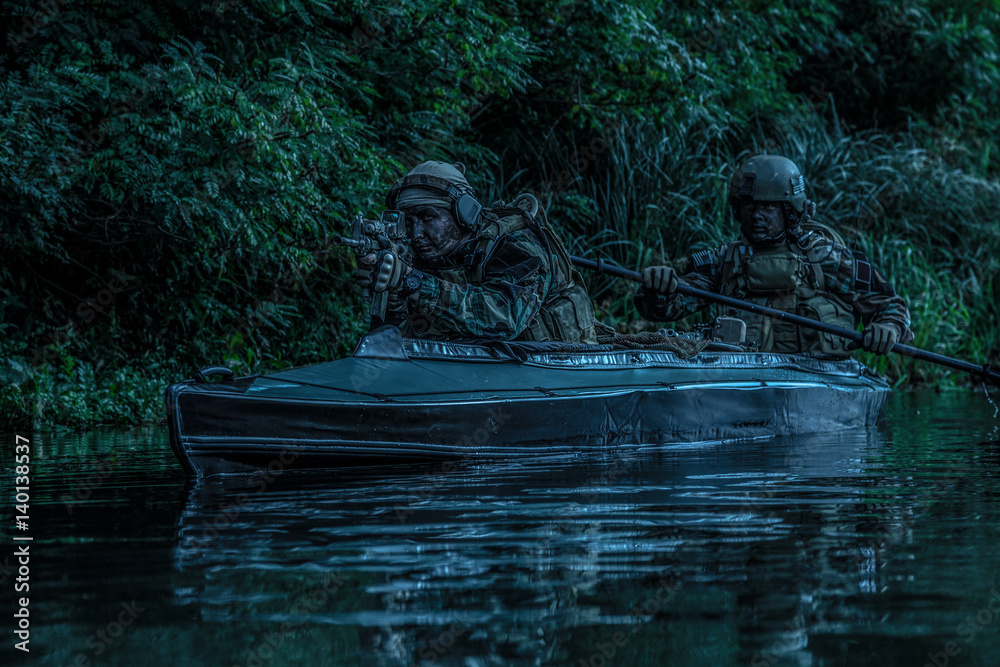 Special forces men with painted faces in camouflage uniforms paddling ...