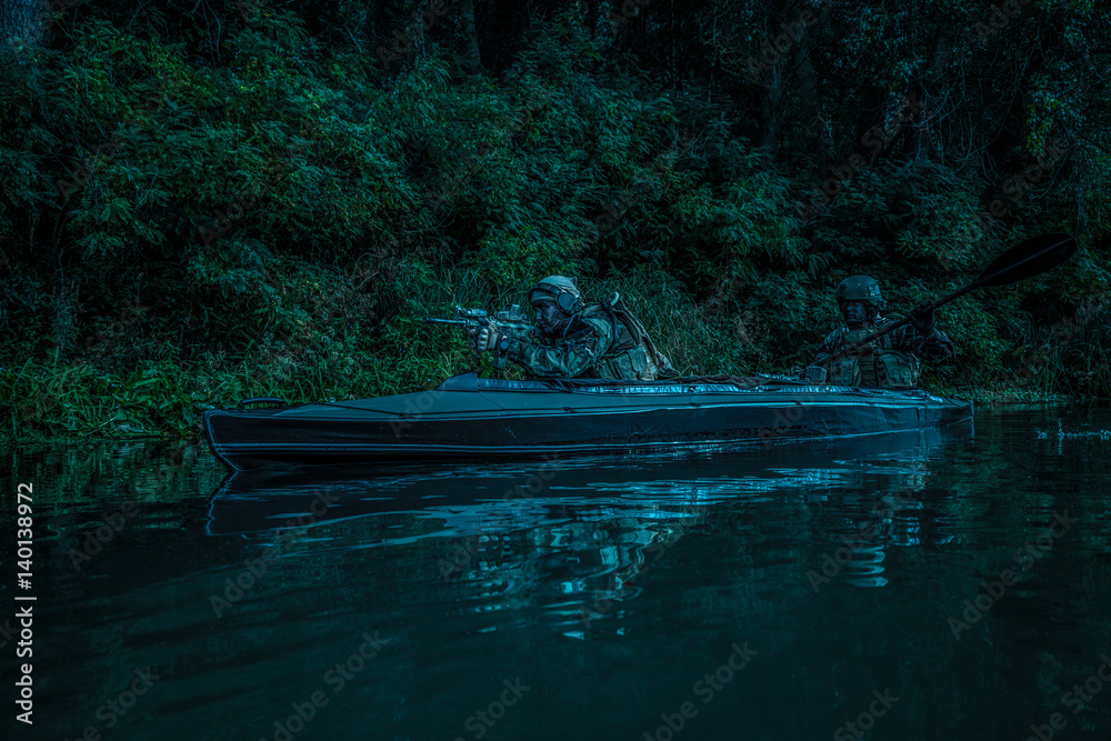 Special forces men with painted faces in camouflage uniforms paddling ...