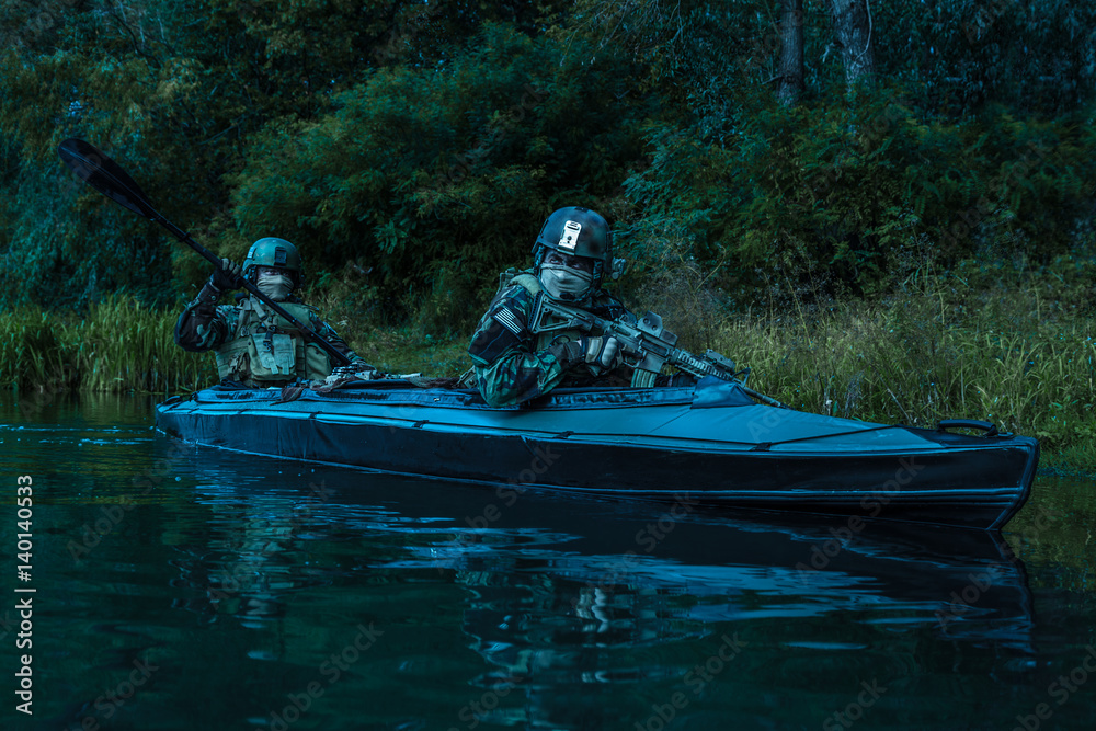 Special forces men with painted faces in camouflage uniforms paddling ...
