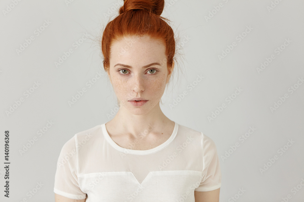 Indoor Portrait Of Attractive Good Looking Redhead Girl With Hair Bun