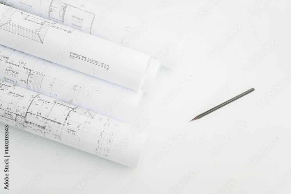 Scroll of architectural drawing and pencil on engineer's working table ...