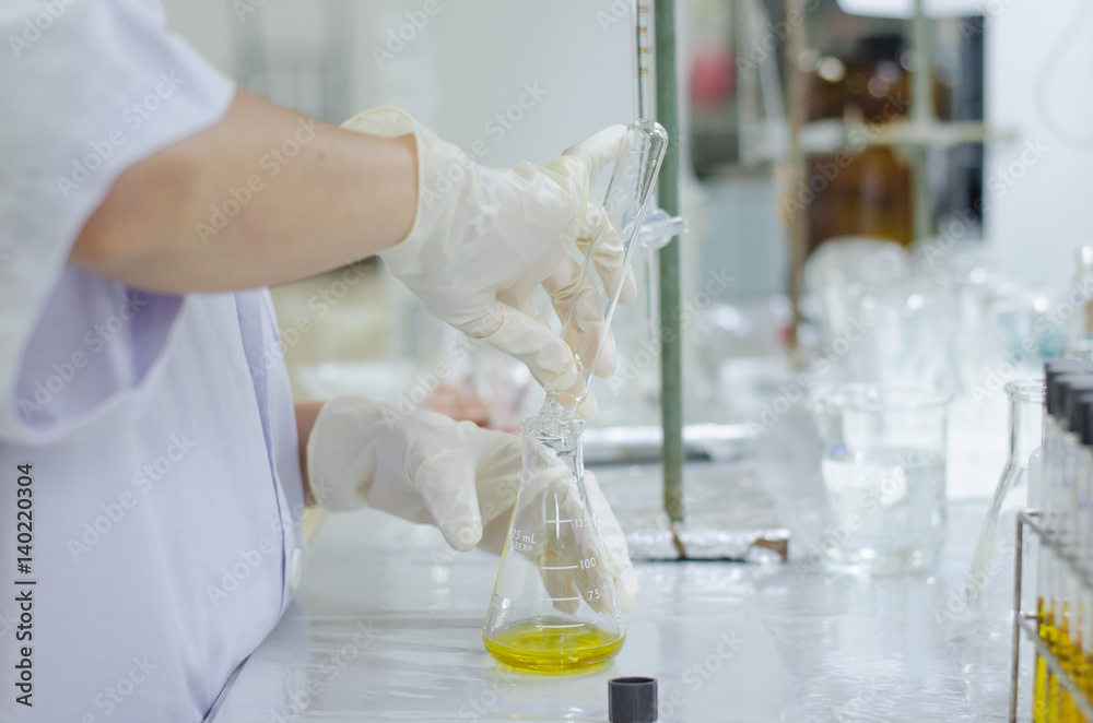 Scientist hand titration at laboratory, titrate chemical, titration ...