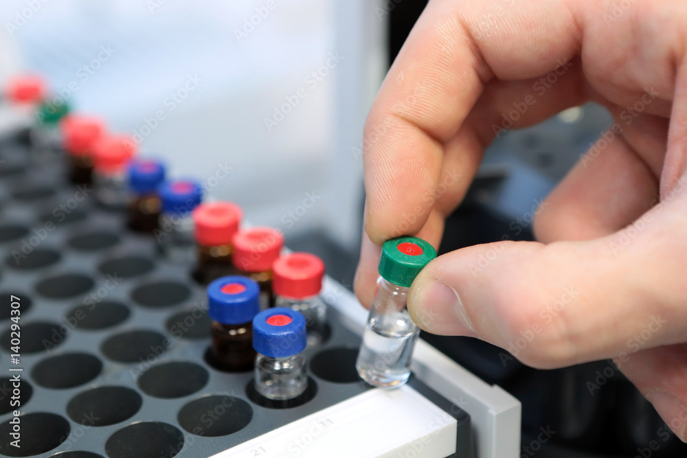 People hand holding a test tube vial sets for analysis in the gas ...