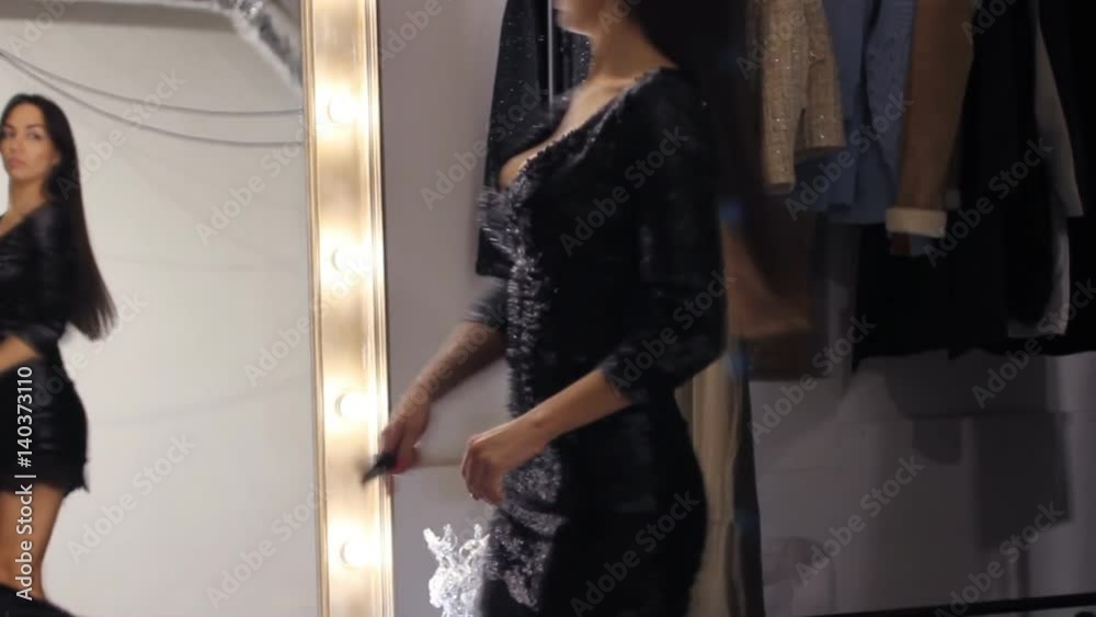 Young beautiful woman combing her long hair with her hand, doing a ...