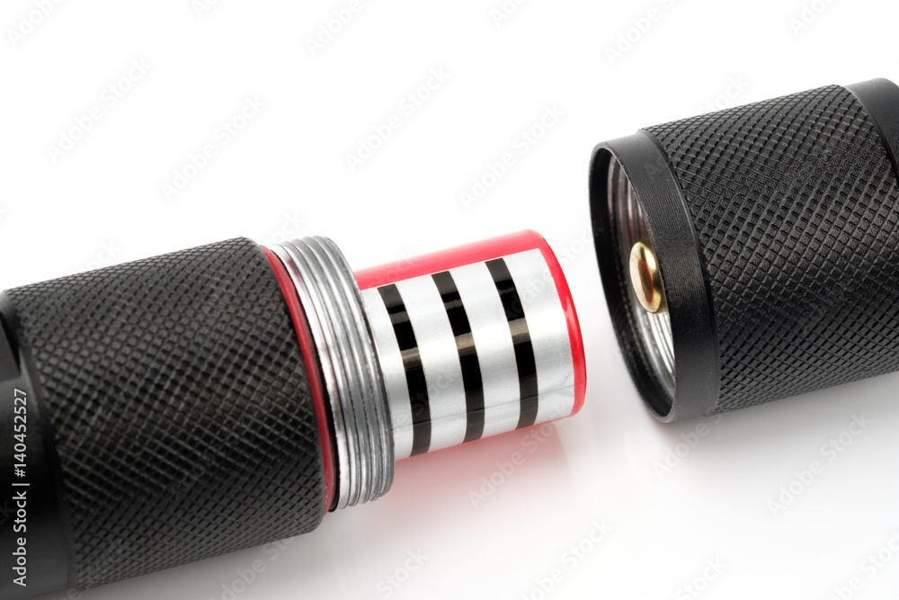 black flashlight opening the tail cap and have red alkaline battery ...