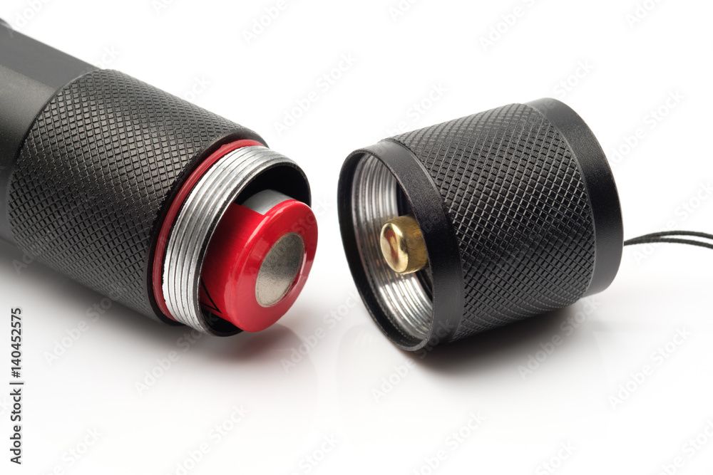 black flashlight opening the tail cap and have red alkaline battery ...