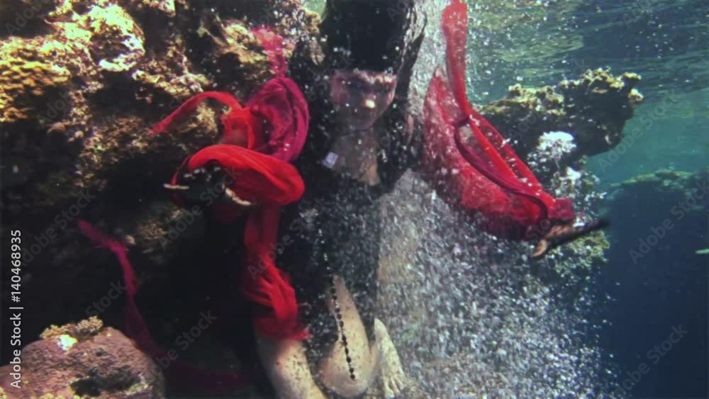 Young girl model free diver underwater in red costume of pirate in Red ...