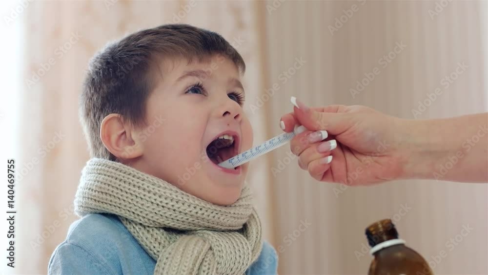 child taking cough syrup, little boy is sick, Mom gives son syrup ...