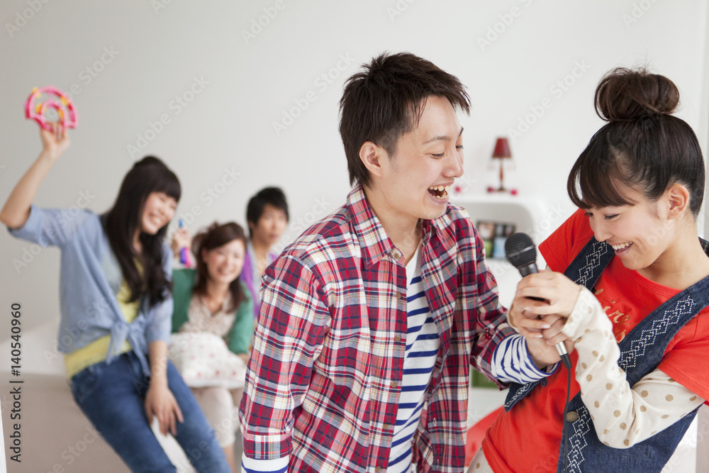 Young people fighting over microphone Stock Photo | Adobe Stock