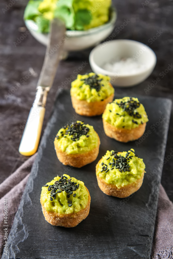 Avocado tartlets made from fresh sliced avocado from above. Dark ...