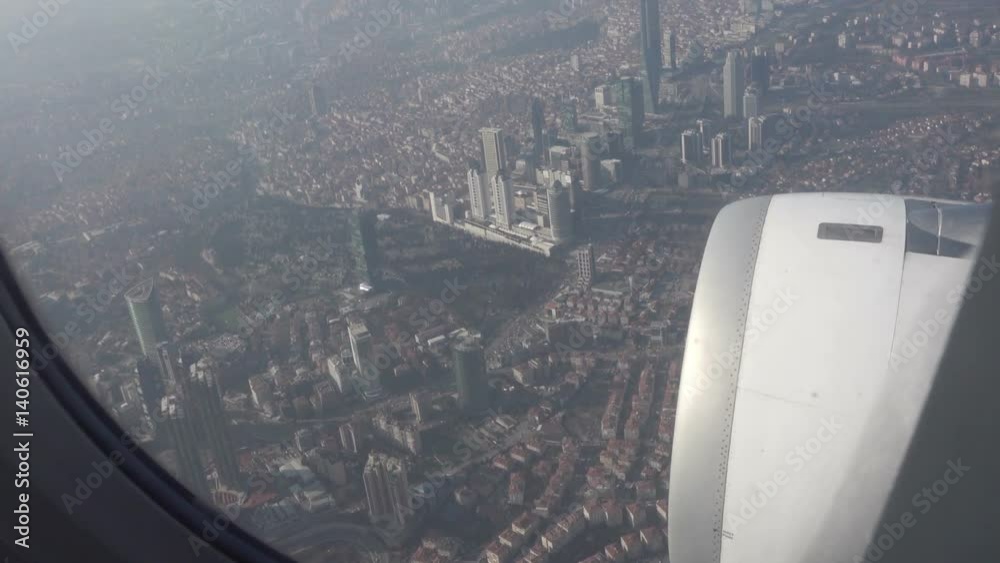 Window view of a commercial passenger aircraft flying over Istanbul ...