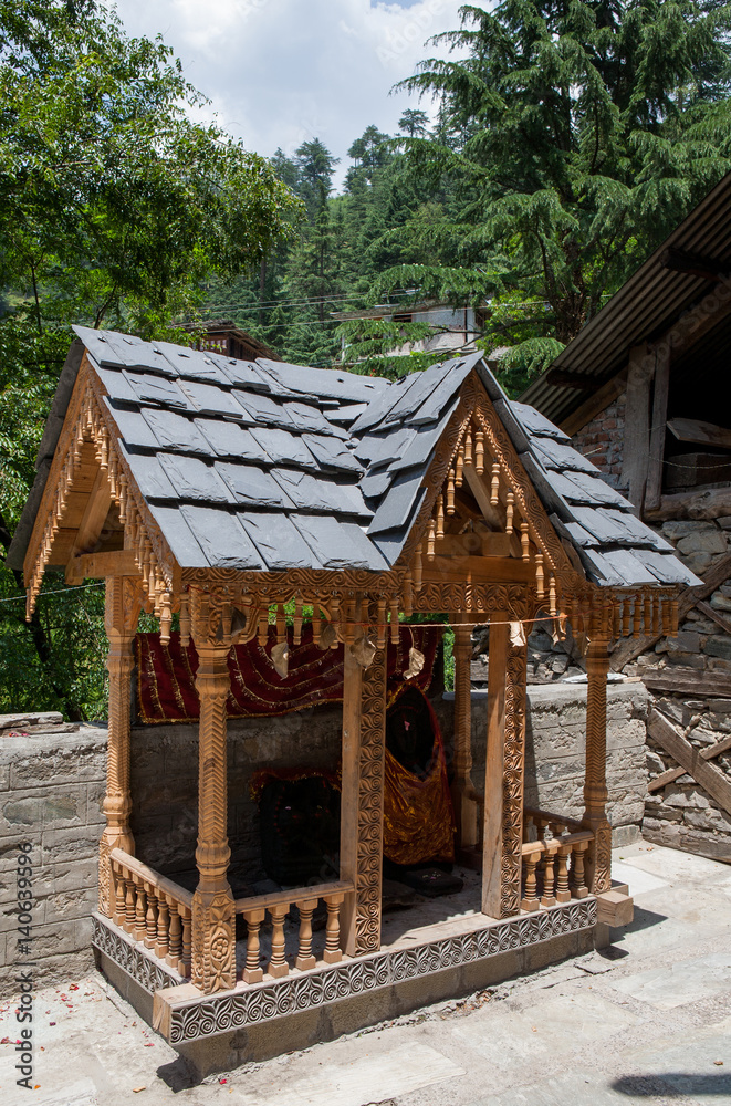 MANALI, INDIA. A small Shiva Temple decorated with wood-carved a ...