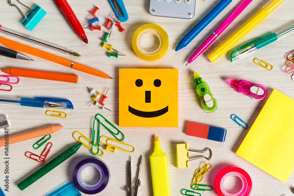 Smiling note emoticon and stationery around it Photos | Adobe Stock