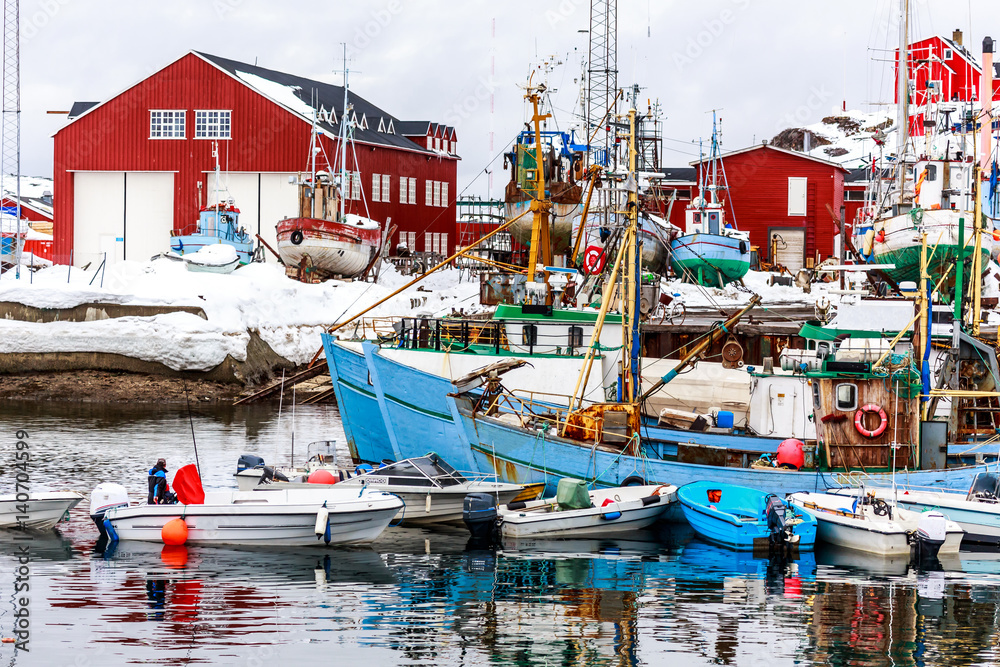 Boats and fishing ships standing on land and water in port of Sisimiut ...