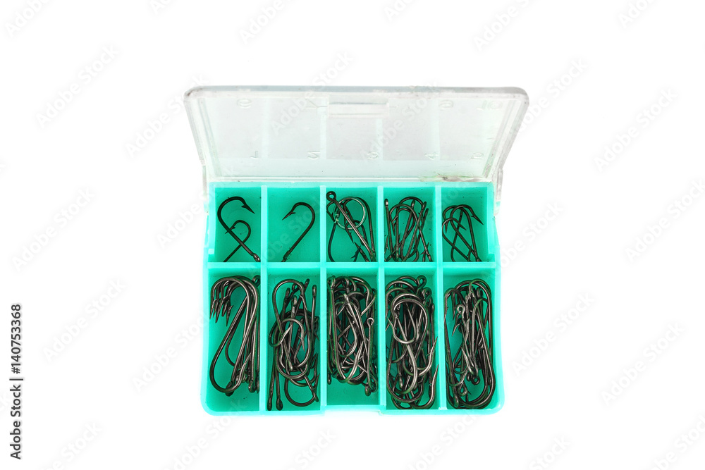 Fish hooks in a box of different sizes on a white isolated background ...