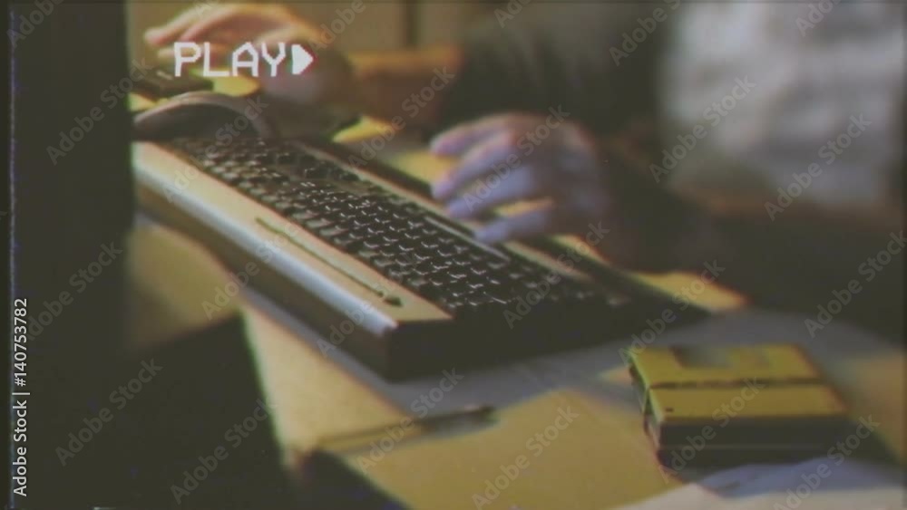 Fake VHS tape: male hands routinely typing on a computer pc keyboard ...