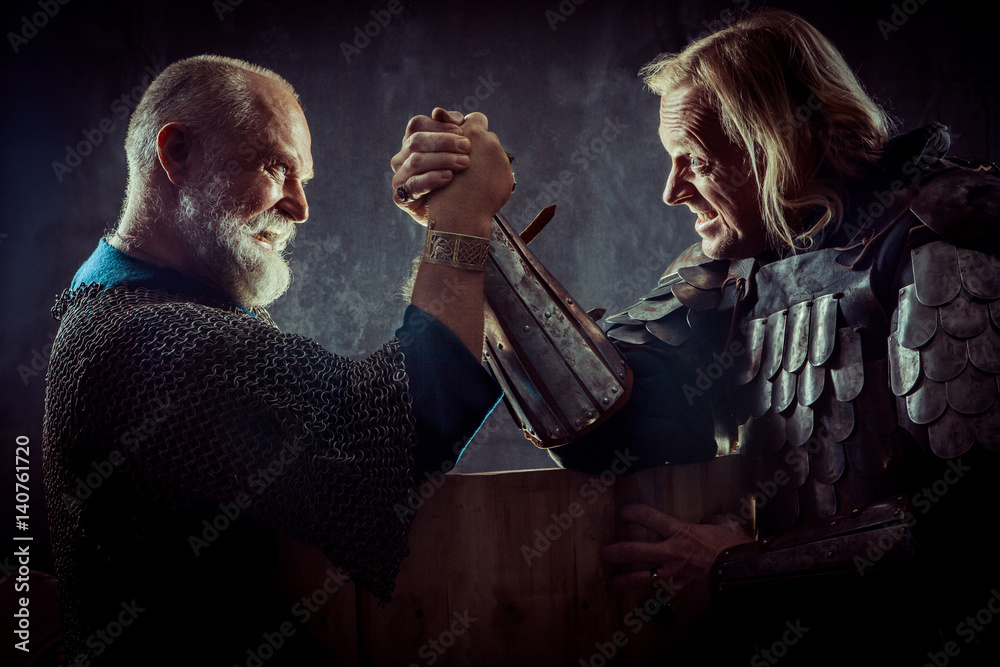 Medieval knights have a hard arm wrestling match Stock Photo | Adobe Stock