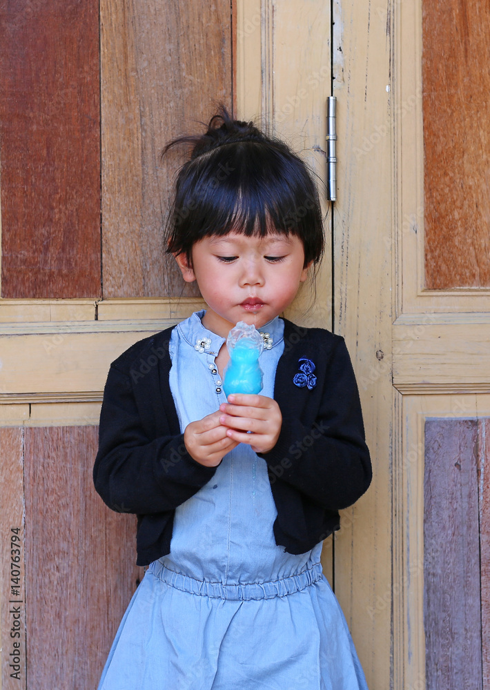 Cute little girl sucking lollipop. Tiny kid enjoying her sweet yummy ...
