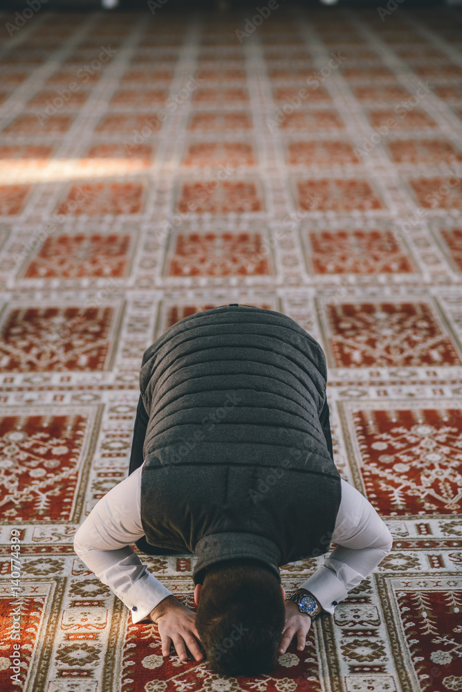 Muslim prostrating on carpet floor of mosque Stock Photo | Adobe Stock