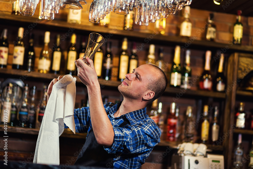 Barman at work in pub,Portrait of cheerful barman worker standing ...