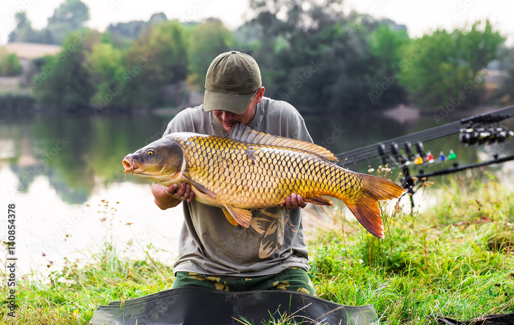 Happy angler with carp fishing trophy Stock-Foto | Adobe Stock