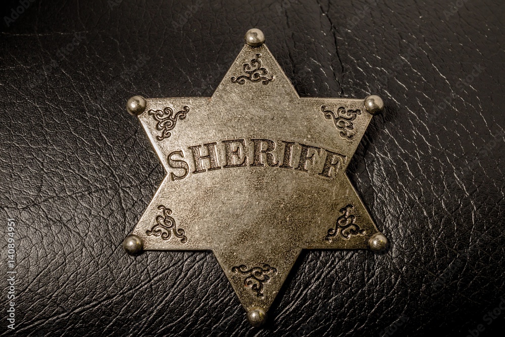 Sheriff badge on black leather texture background. Macro shot. Stock ...