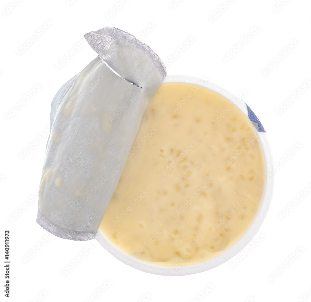 Tapioca pudding in an opened container with the lid peeled back ...