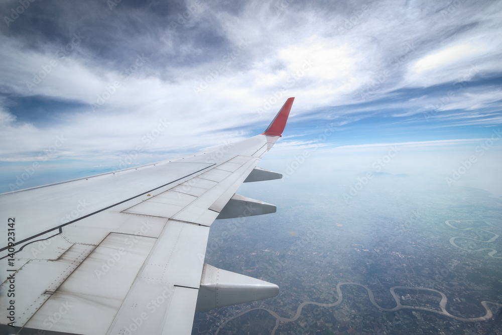 Clouds and sky as seen through window of an aircraft. Looking through ...