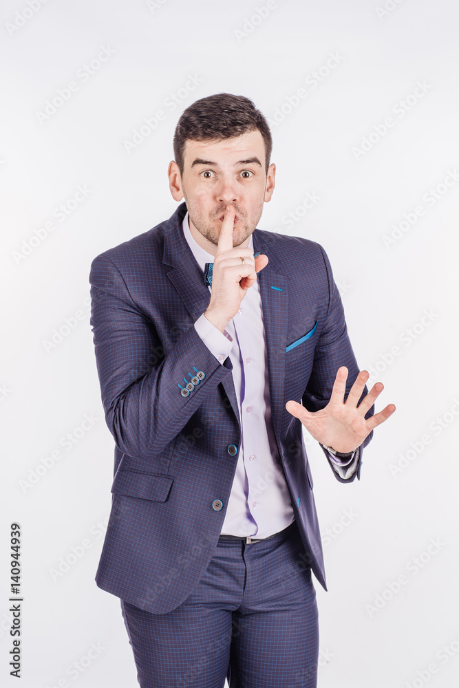 man making a shushing gesture raising his finger to his lips. emotions ...
